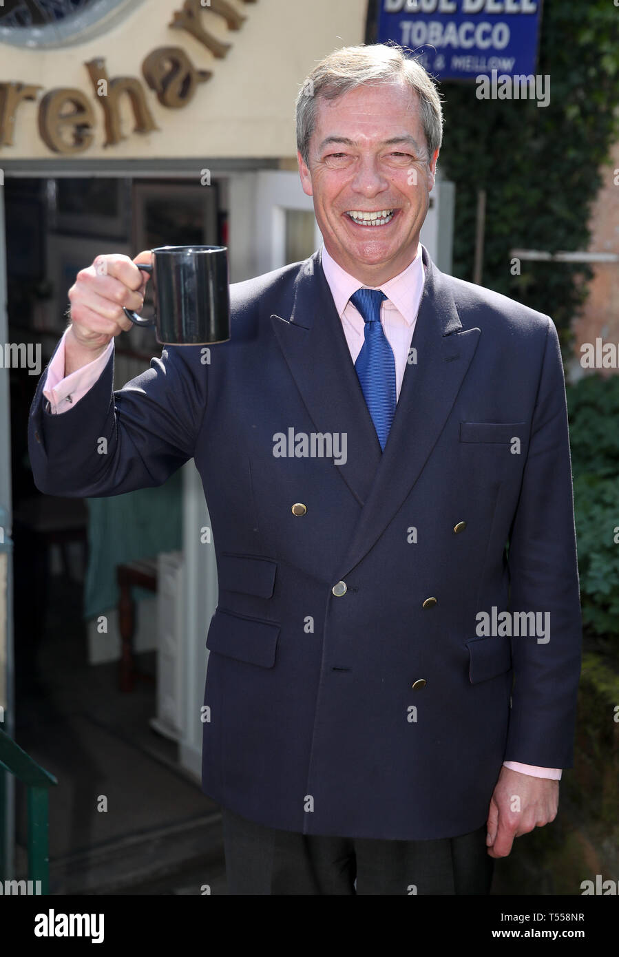 Brexit Party leader Nigel Farage holds a mug of tea as he visits the ...