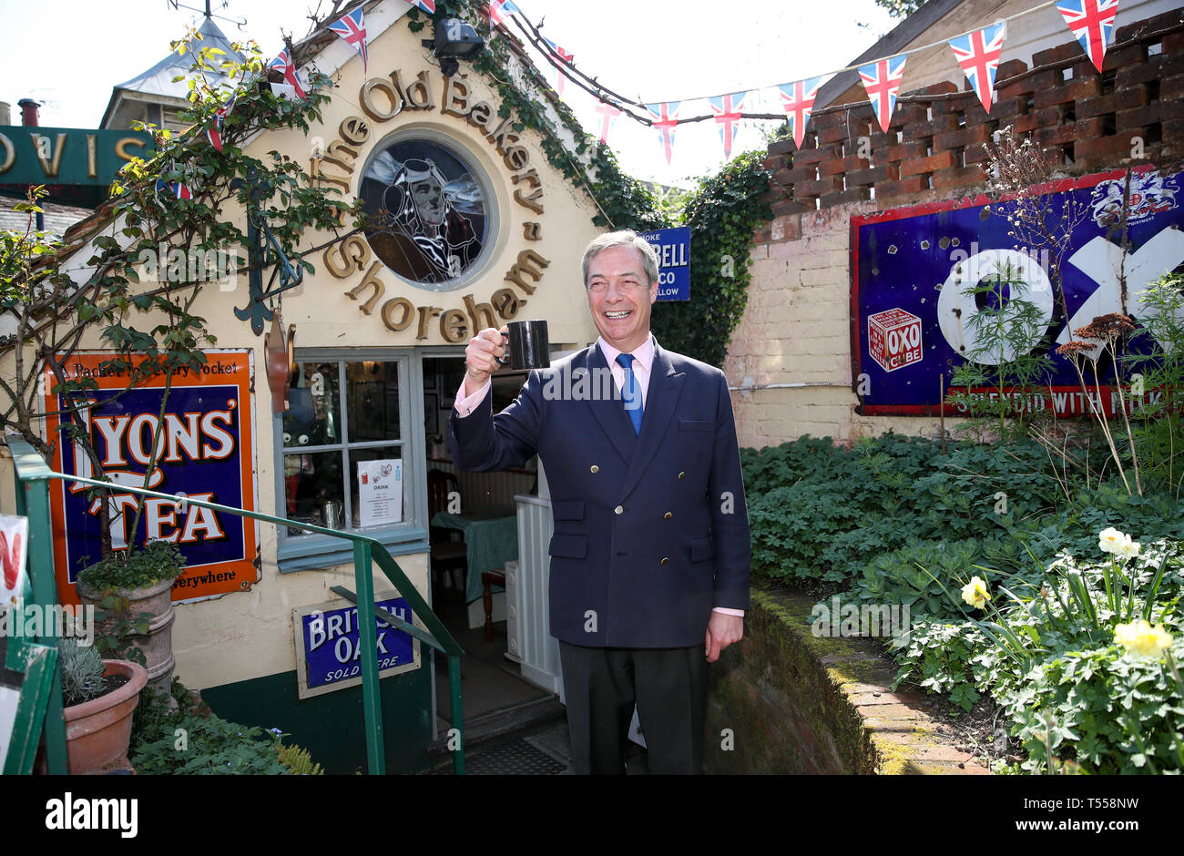 Brexit Party leader Nigel Farage holds a mug of tea as he visits the ...