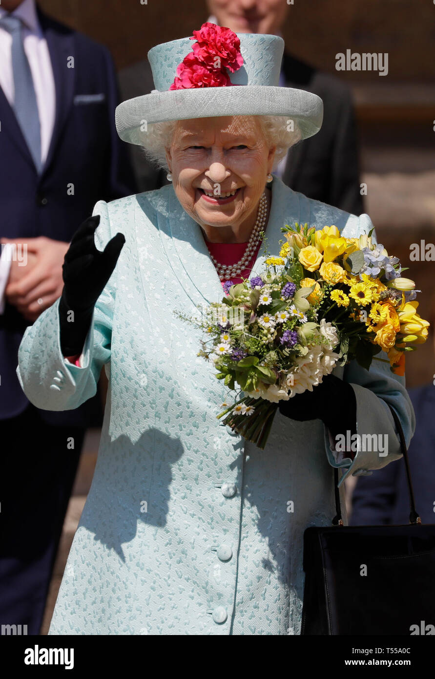 Queen Elizabeth II is presented with flowers as she leaves the Easter ...