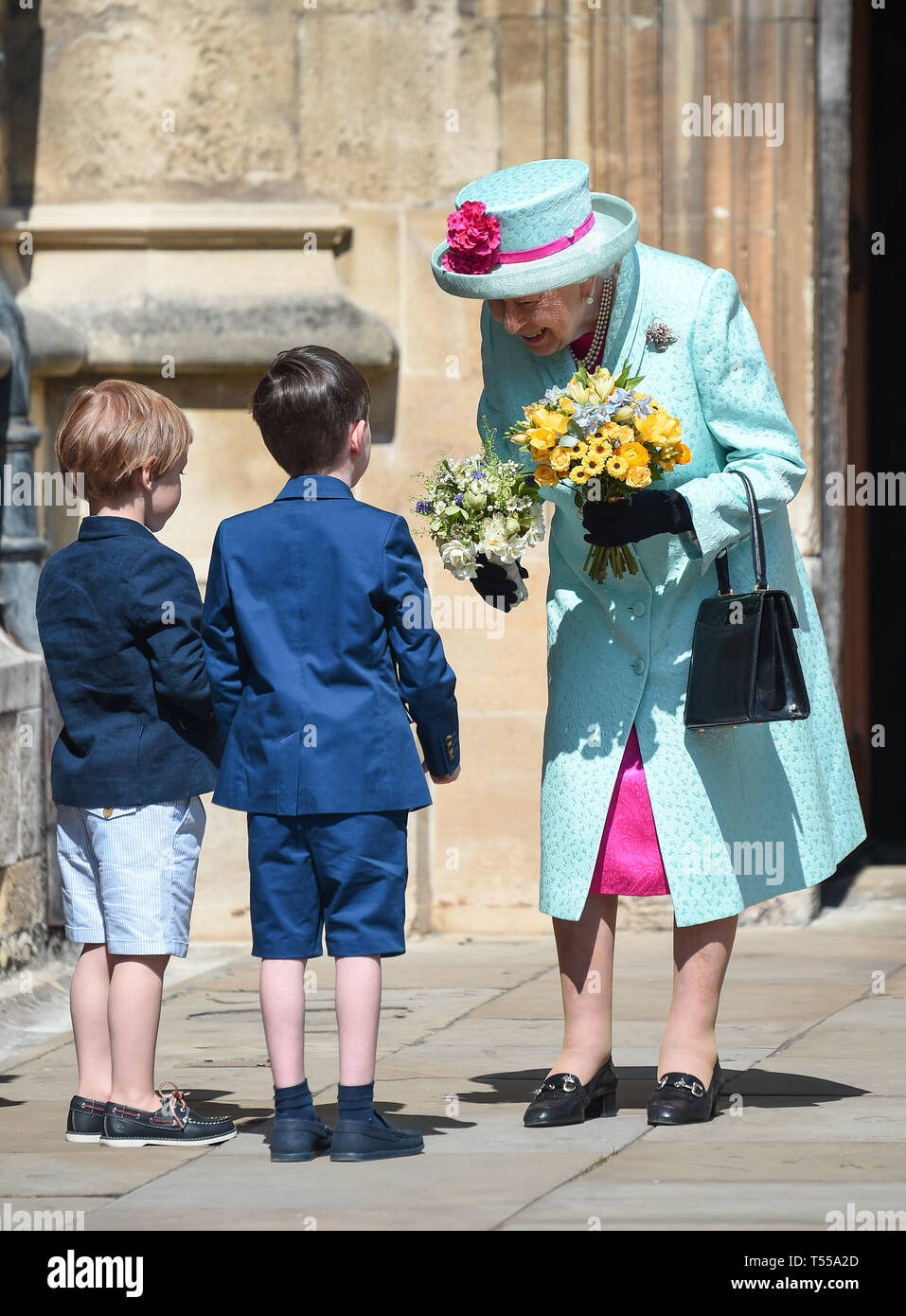 Queen Elizabeth II is presented with flowers as she leaves the Easter ...