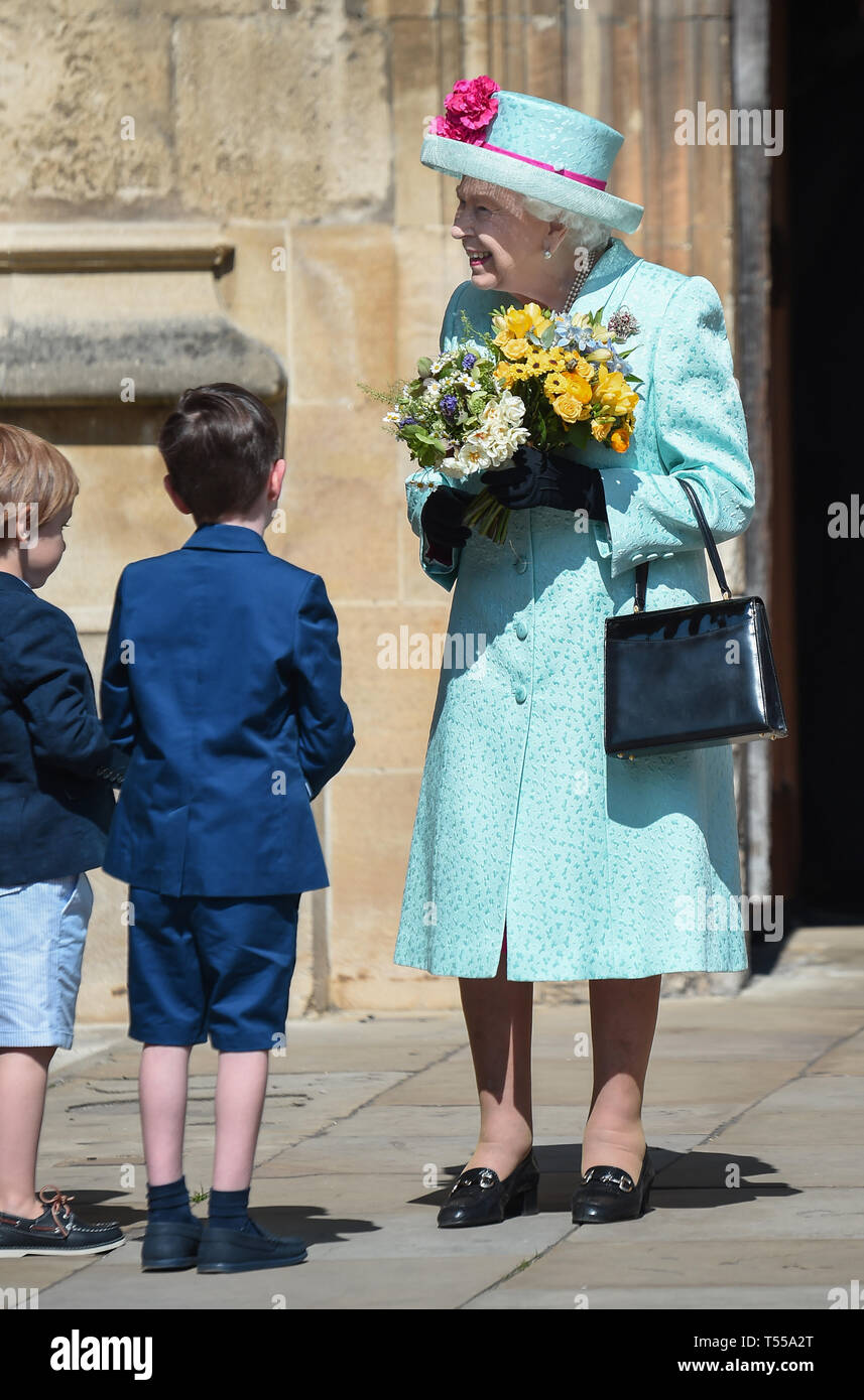 Queen Elizabeth II is presented with flowers as she leaves the Easter ...