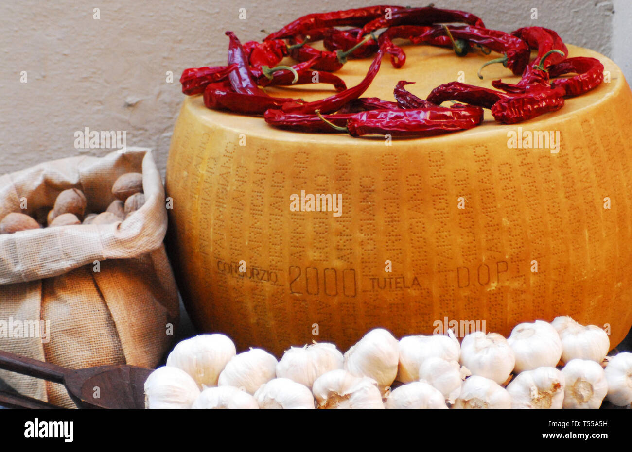 Beautiful display in an Italian market includes garlic, peppers, a bag ...