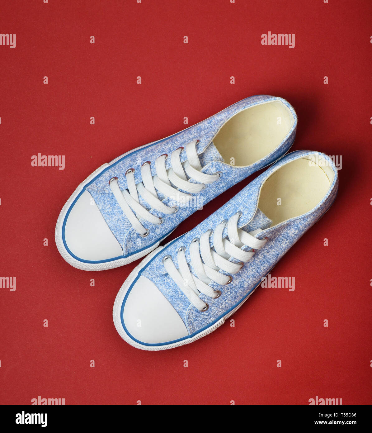 Classic retro sneakers on a red background. Top view. Women's shoes ...
