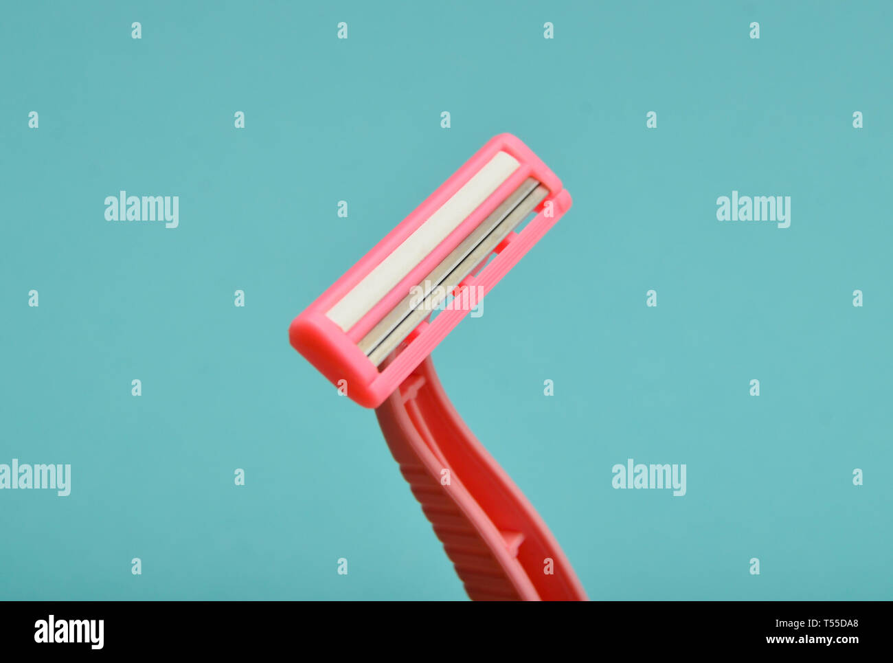 Plastic razor for depilation close-up on a blue background Stock Photo ...