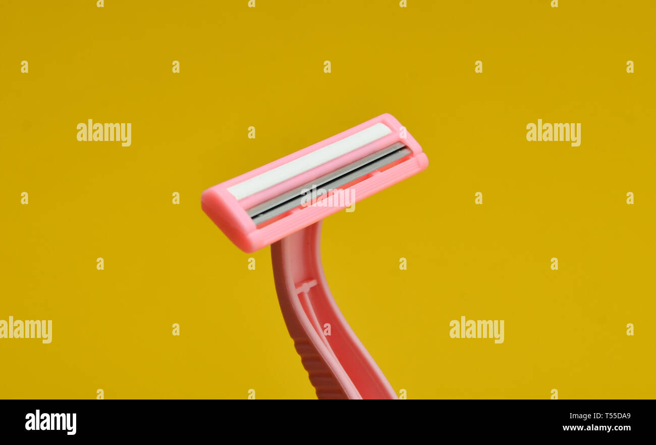 Plastic razor for depilation close-up on a yellow background Stock ...