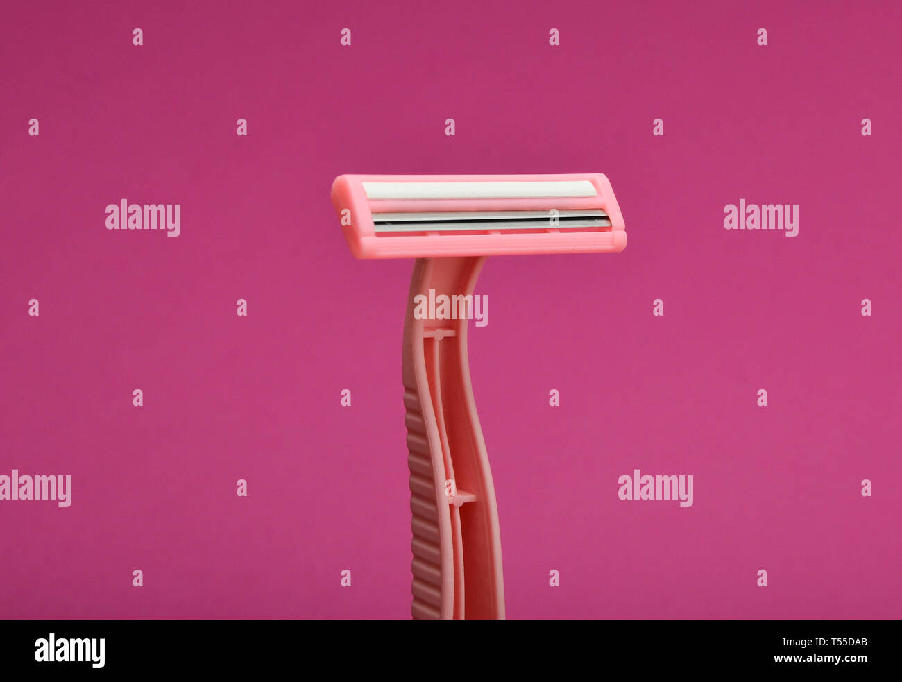 Pink disposable razor for depilation on a pink background Stock Photo ...
