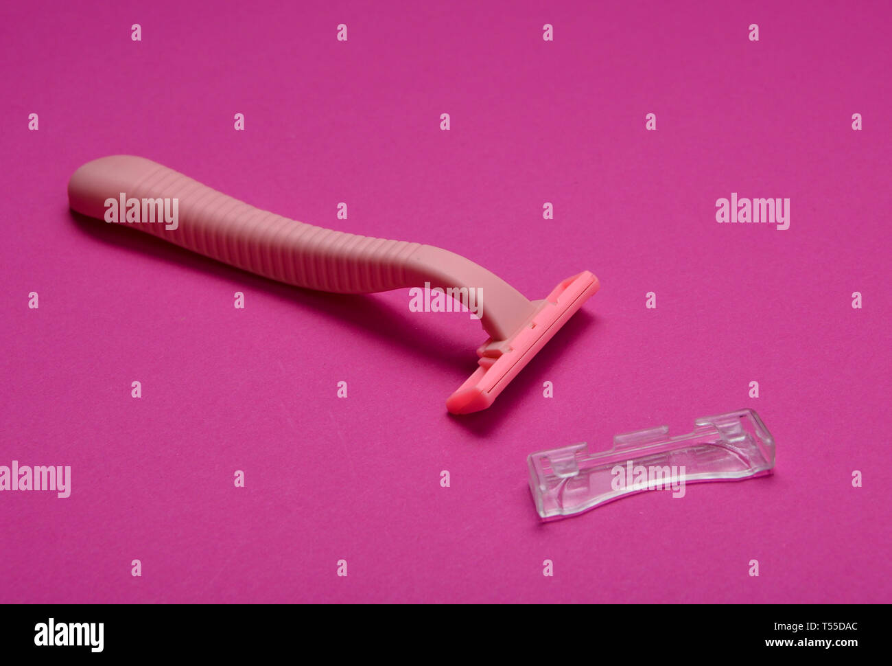 Pink disposable razor for depilation on a pink background Stock Photo ...