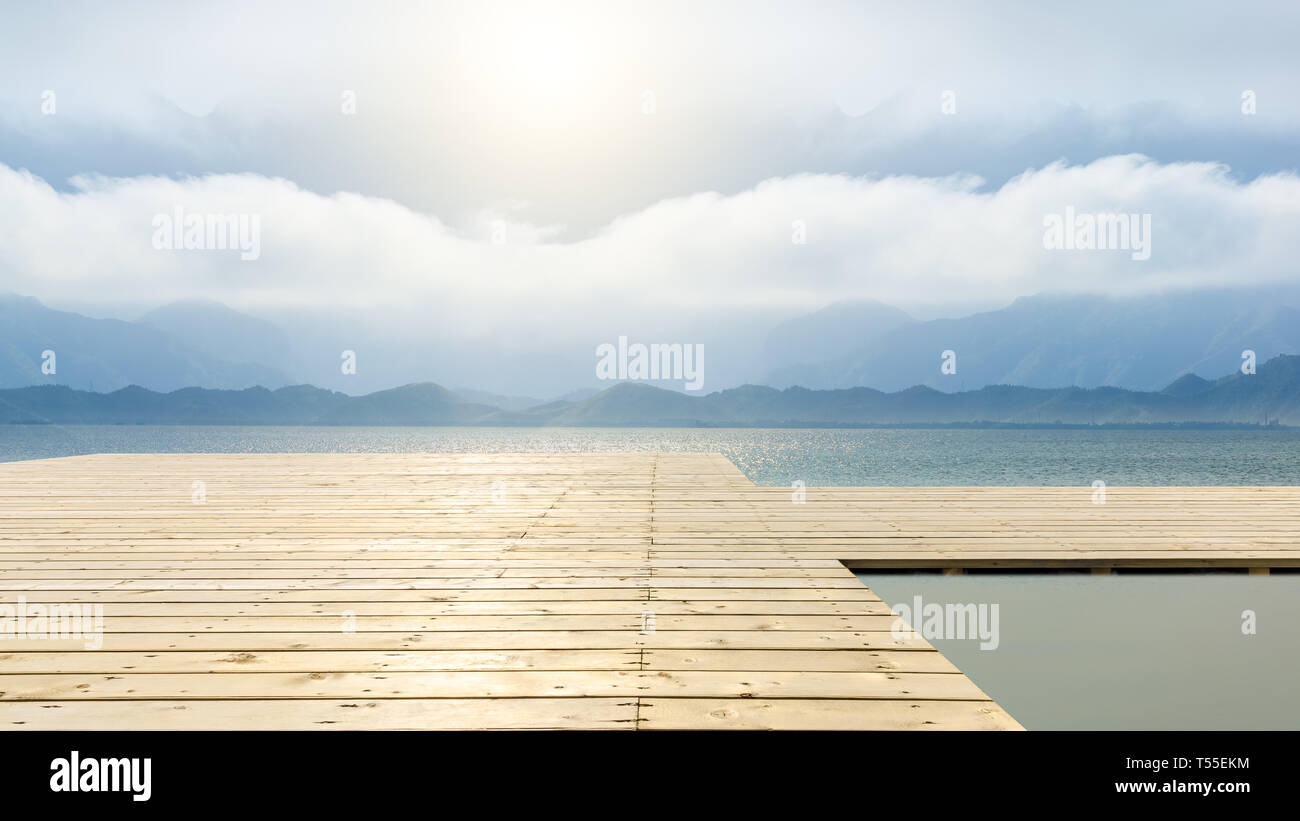 Wooden floor platform and lake with sky background Stock Photo - Alamy