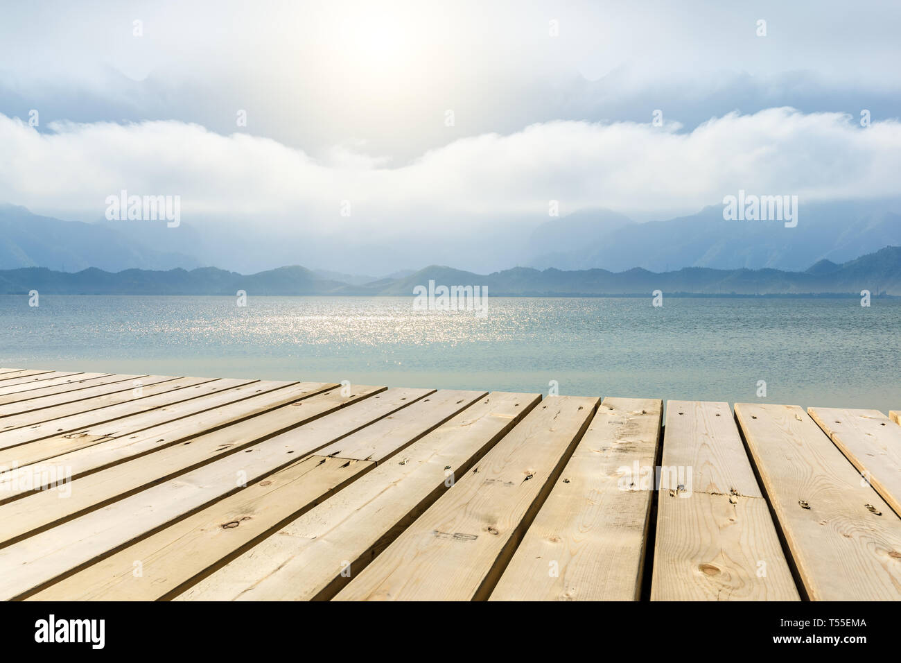 Wooden floor platform and lake with sky background Stock Photo - Alamy