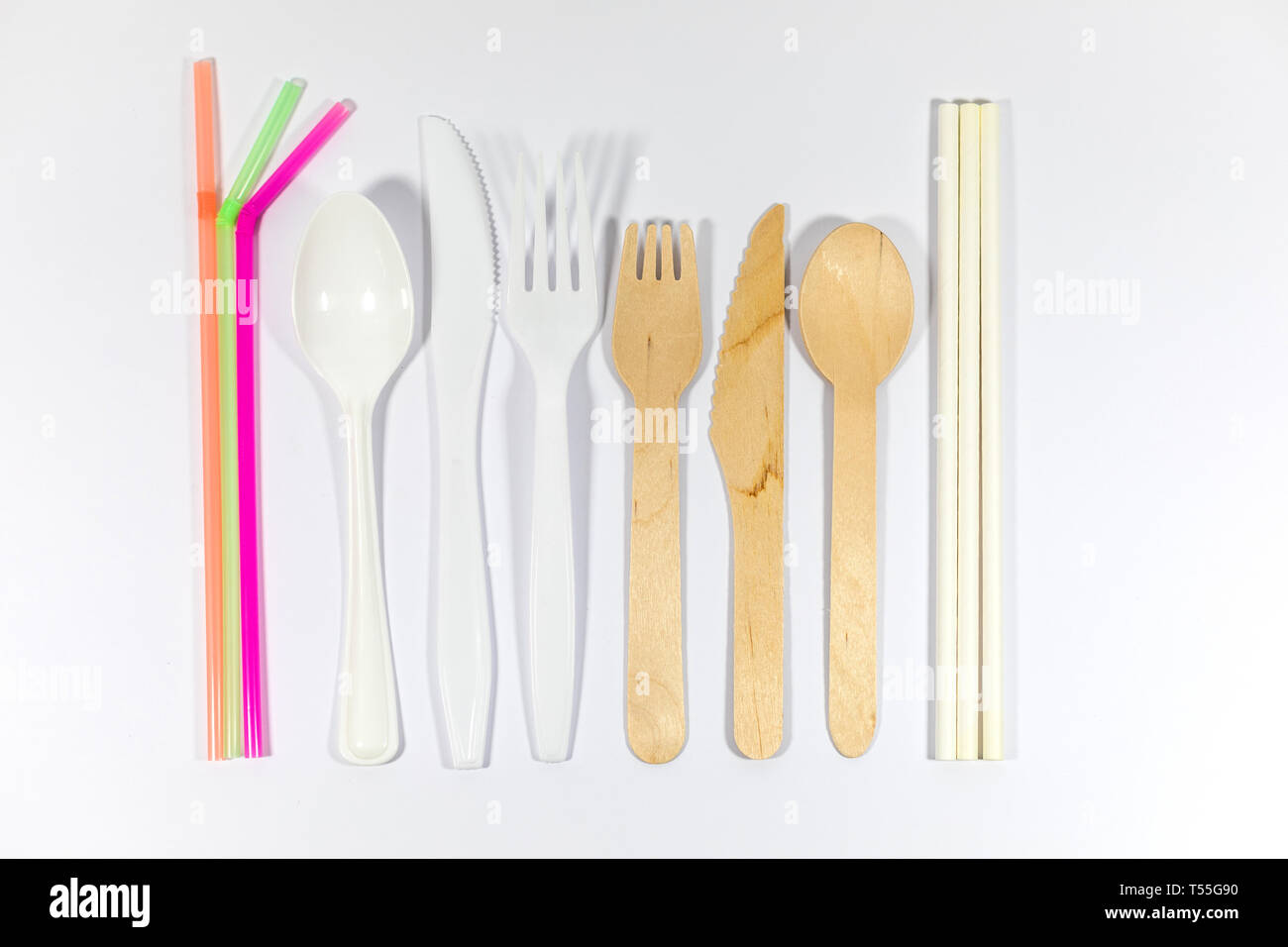 Wooden biodegradable utensils and paper straws, side by side with their ...