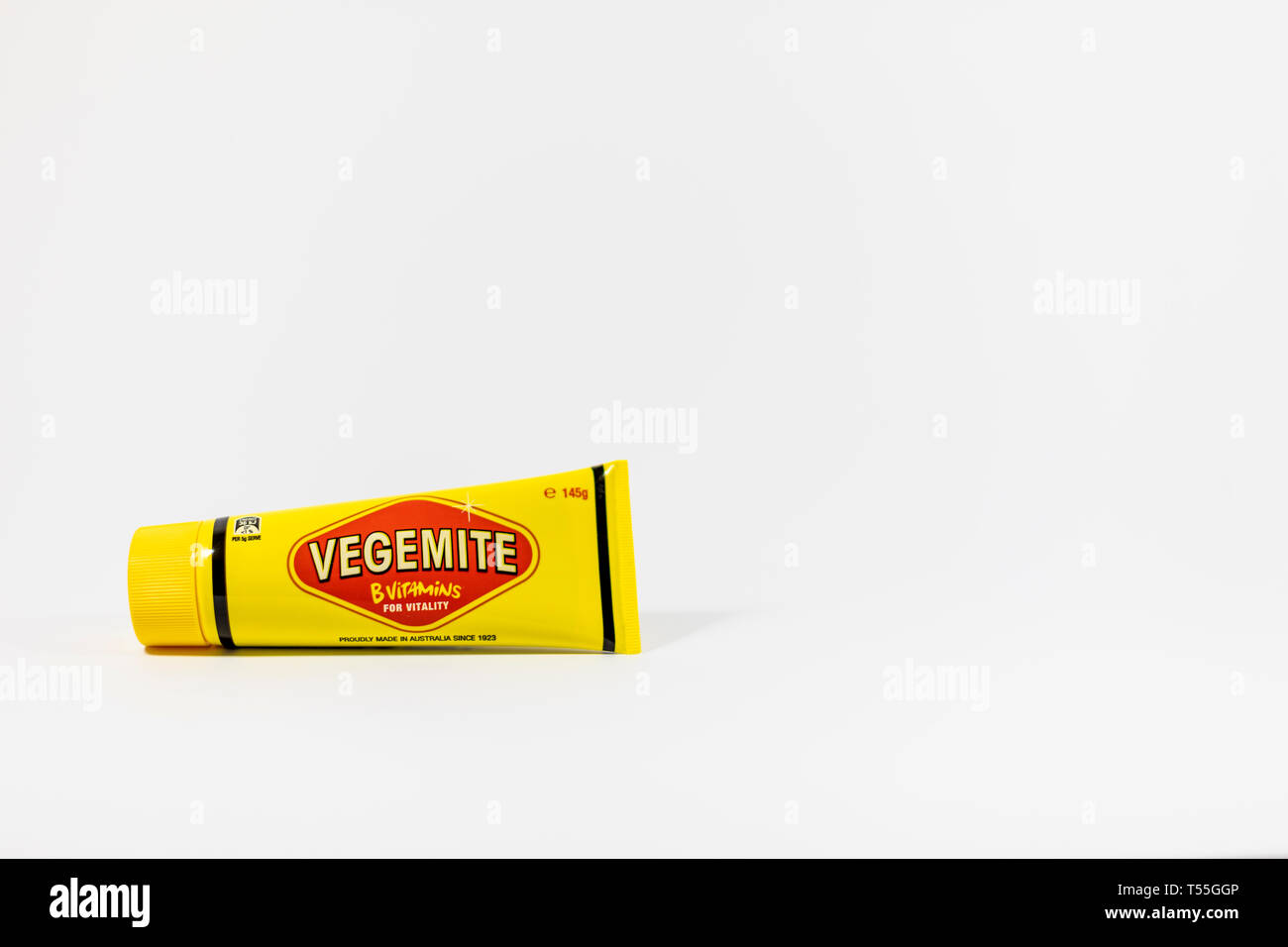 A single tube of squeezable Vegemite set against a white background ...
