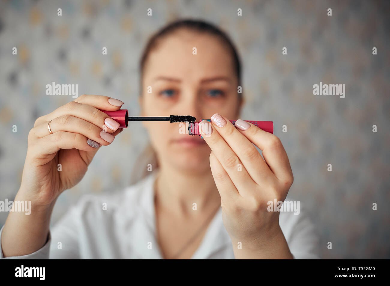 the lifestyle of a Caucasian woman holding a mascara to make yourself a ...