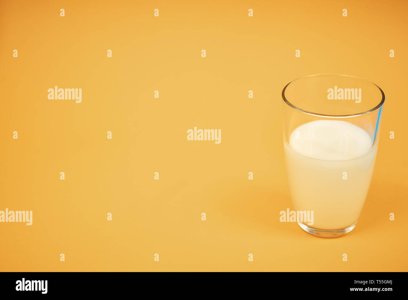 glass of milk on a colored background Stock Photo - Alamy