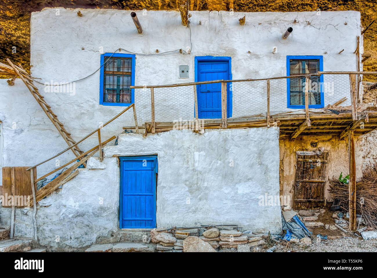 White adobe house with wooden stairs in a village, Ermenek, Anatolia ...