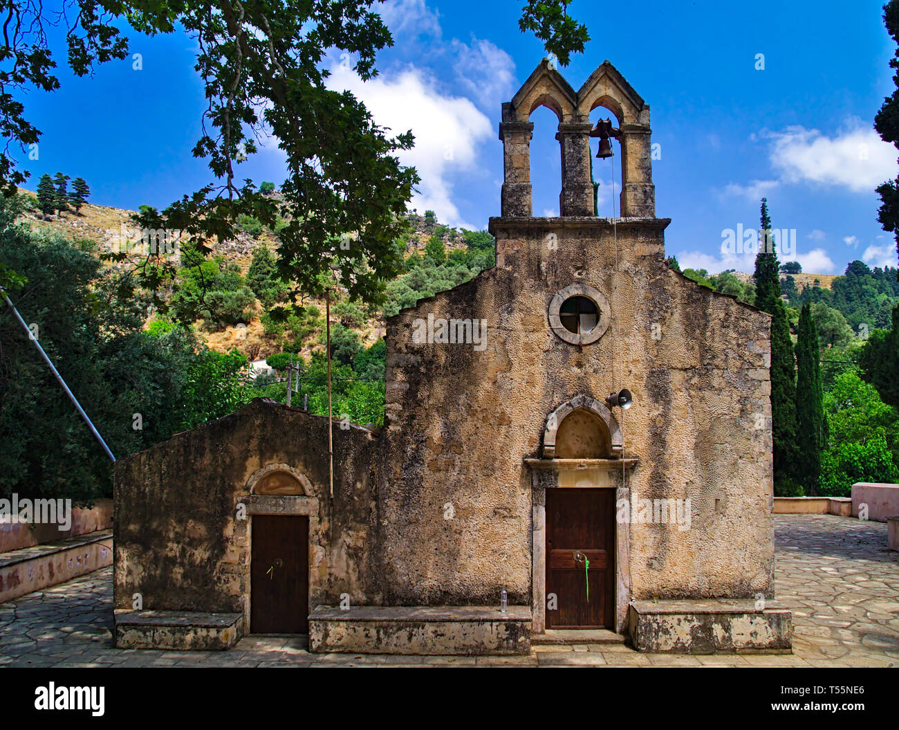 Beautiful old chapel facade in Crete island, Greece. Blue sky with some ...