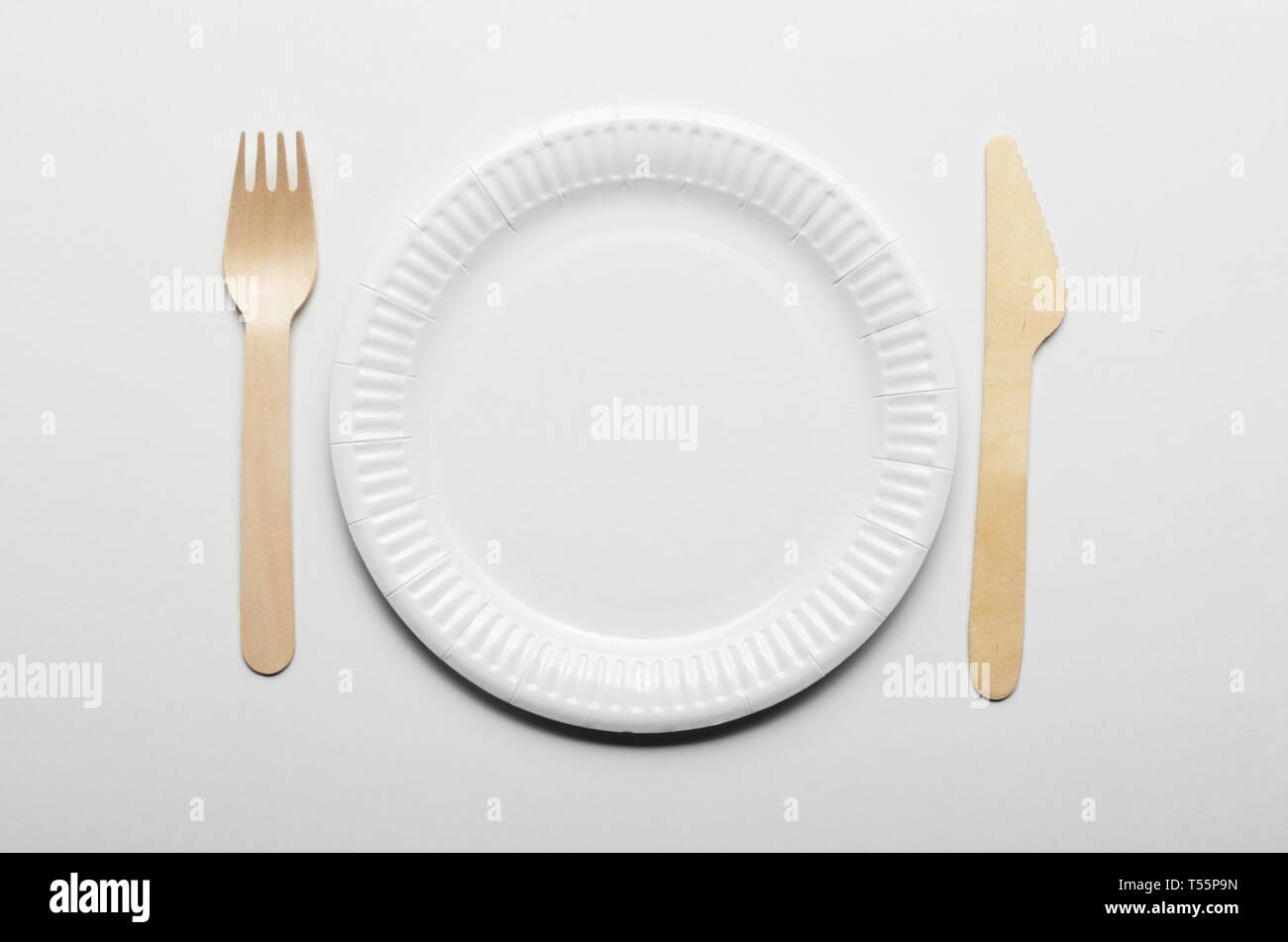 Wooden single use kitchenware and paper plate on white background ...
