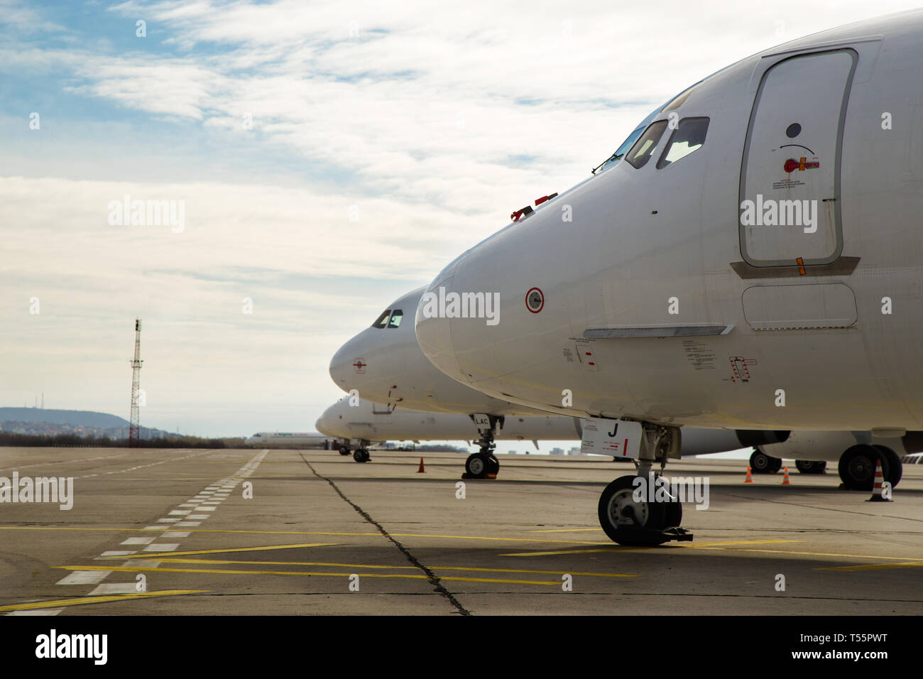 Passenger and commercial aircraft row, airplane parked on service ...