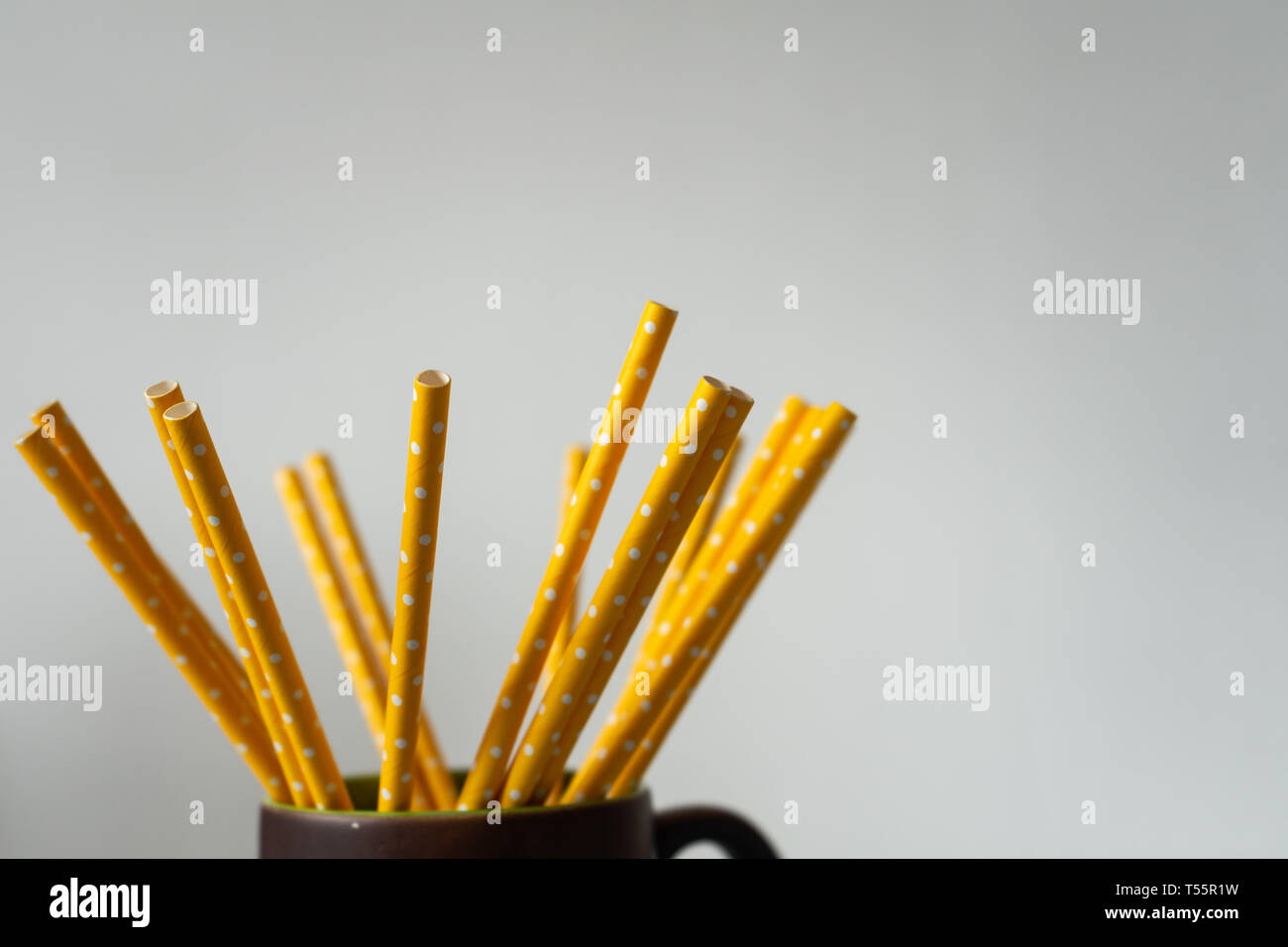 Yellow paper straws isolated on white background Stock Photo - Alamy