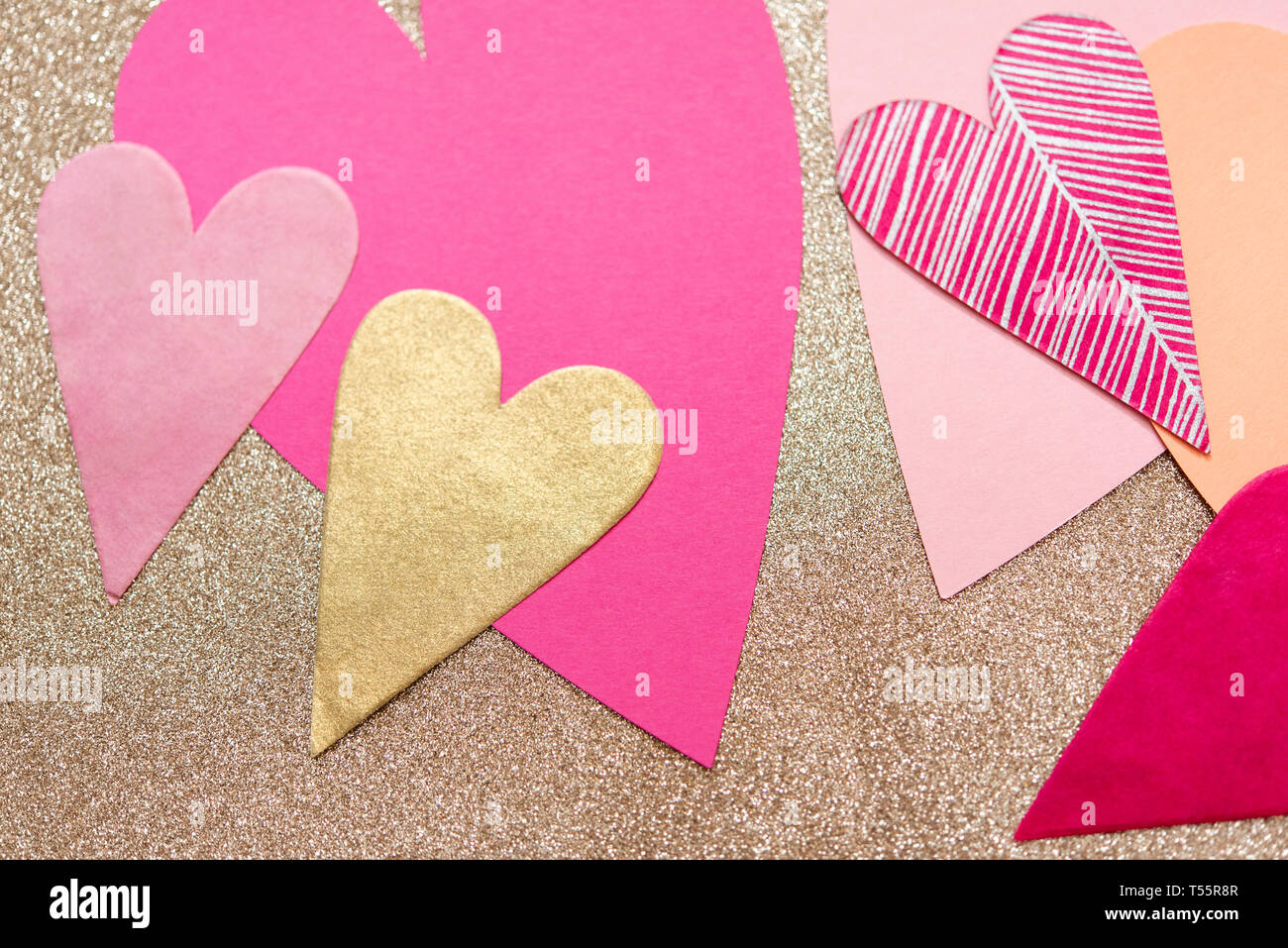 Pink and gold paper hearts Stock Photo - Alamy