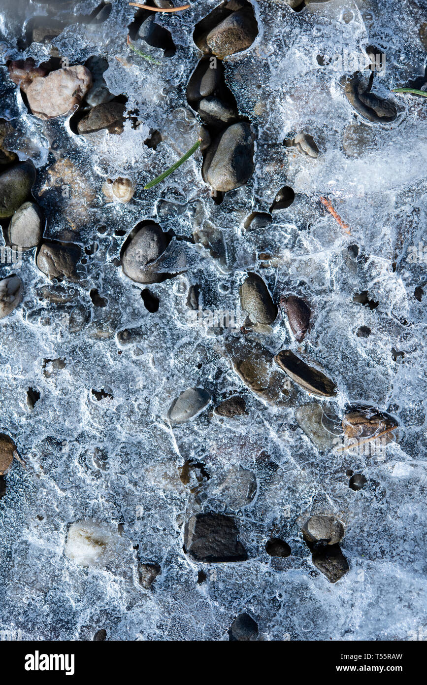 Ice over pebbles Stock Photo - Alamy