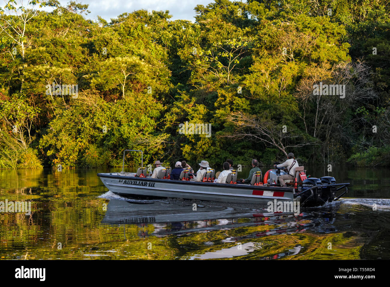 Tourists exploring the Amazon on a skiff Stock Photo - Alamy