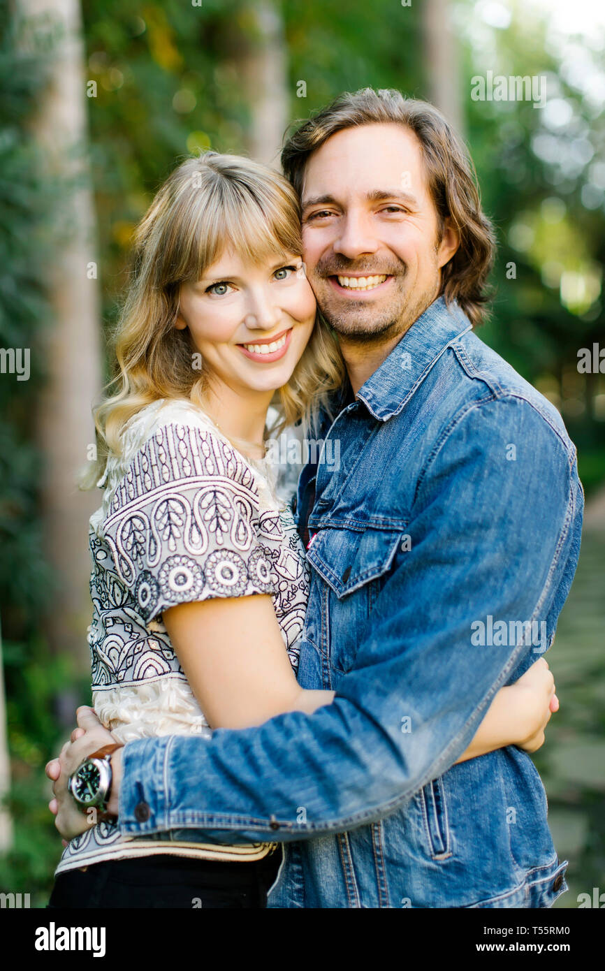 Mid adult couple embracing Stock Photo - Alamy