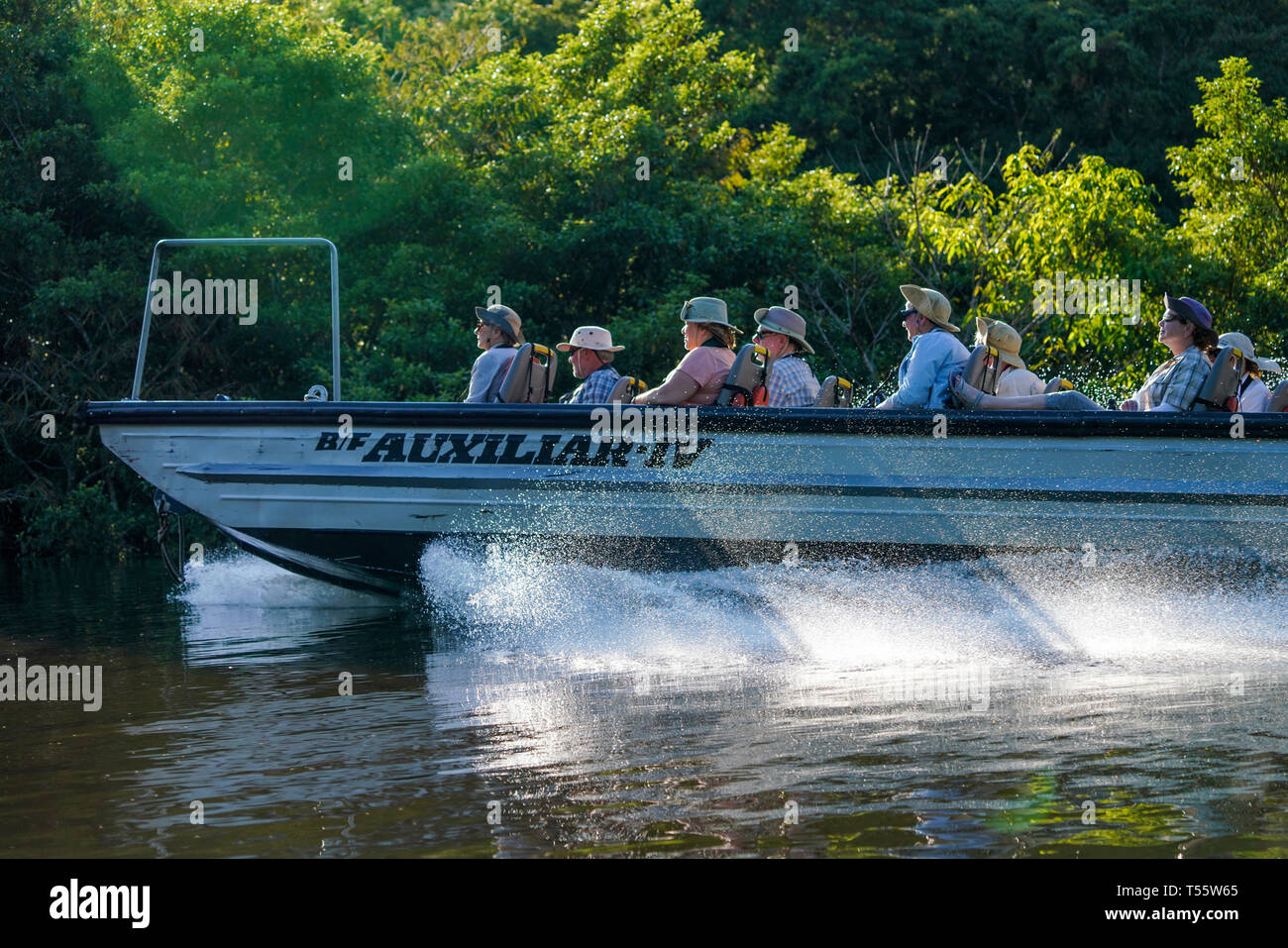 Tourists exploring the Amazon on a skiff Stock Photo - Alamy