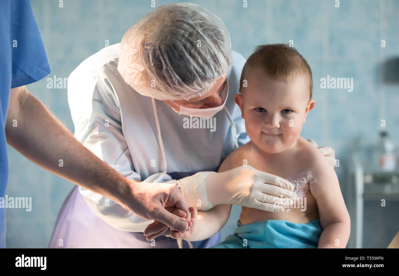 To a little boy, a nurse heals a burn.Kid in the hospital wounded.The ...