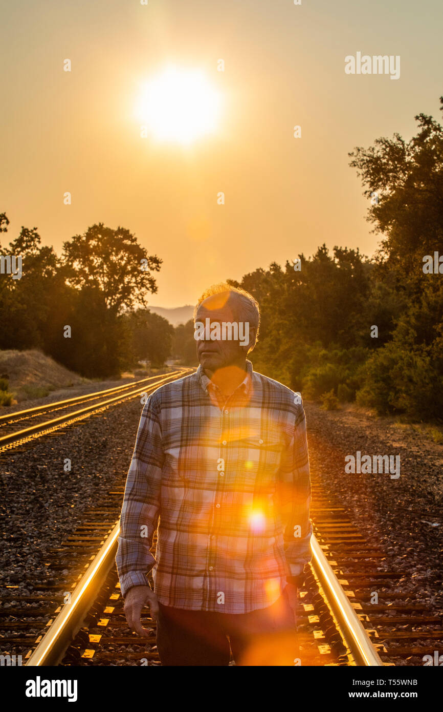 Man walking on railroad tracks hi-res stock photography and images - Alamy
