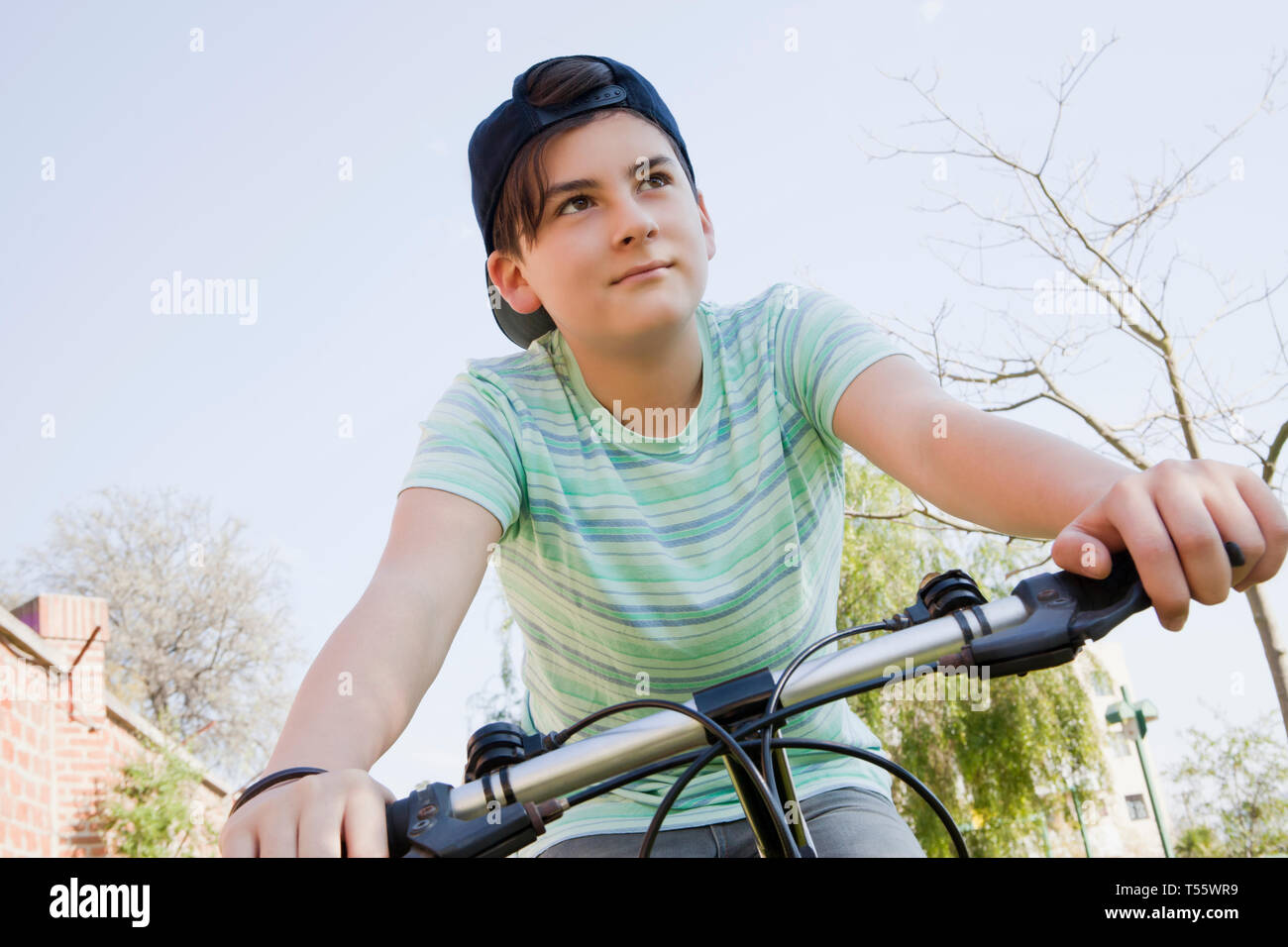 Teenage boy cycling in park Stock Photo - Alamy