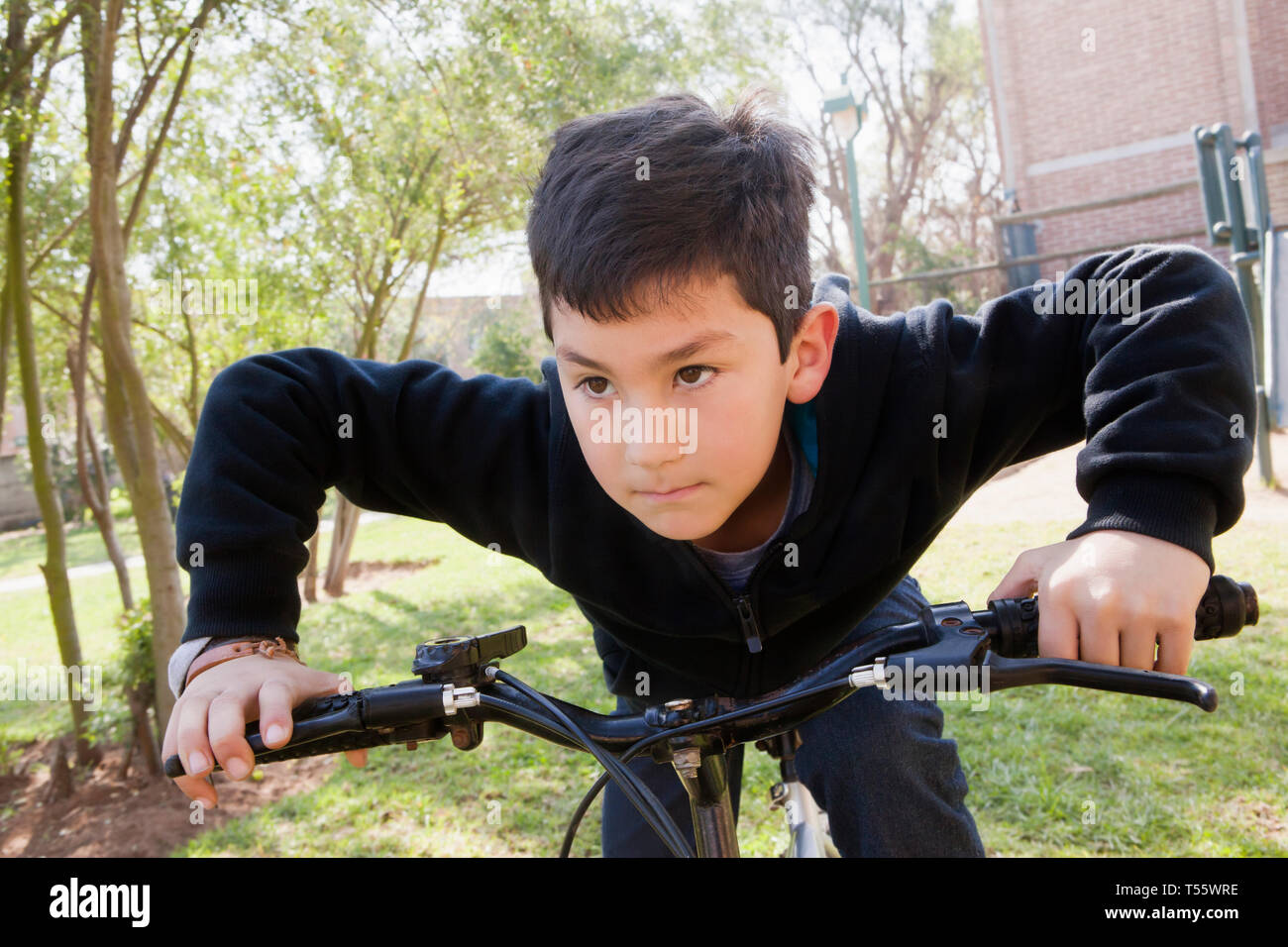 Boy riding bicycle in black hi-res stock photography and images - Alamy