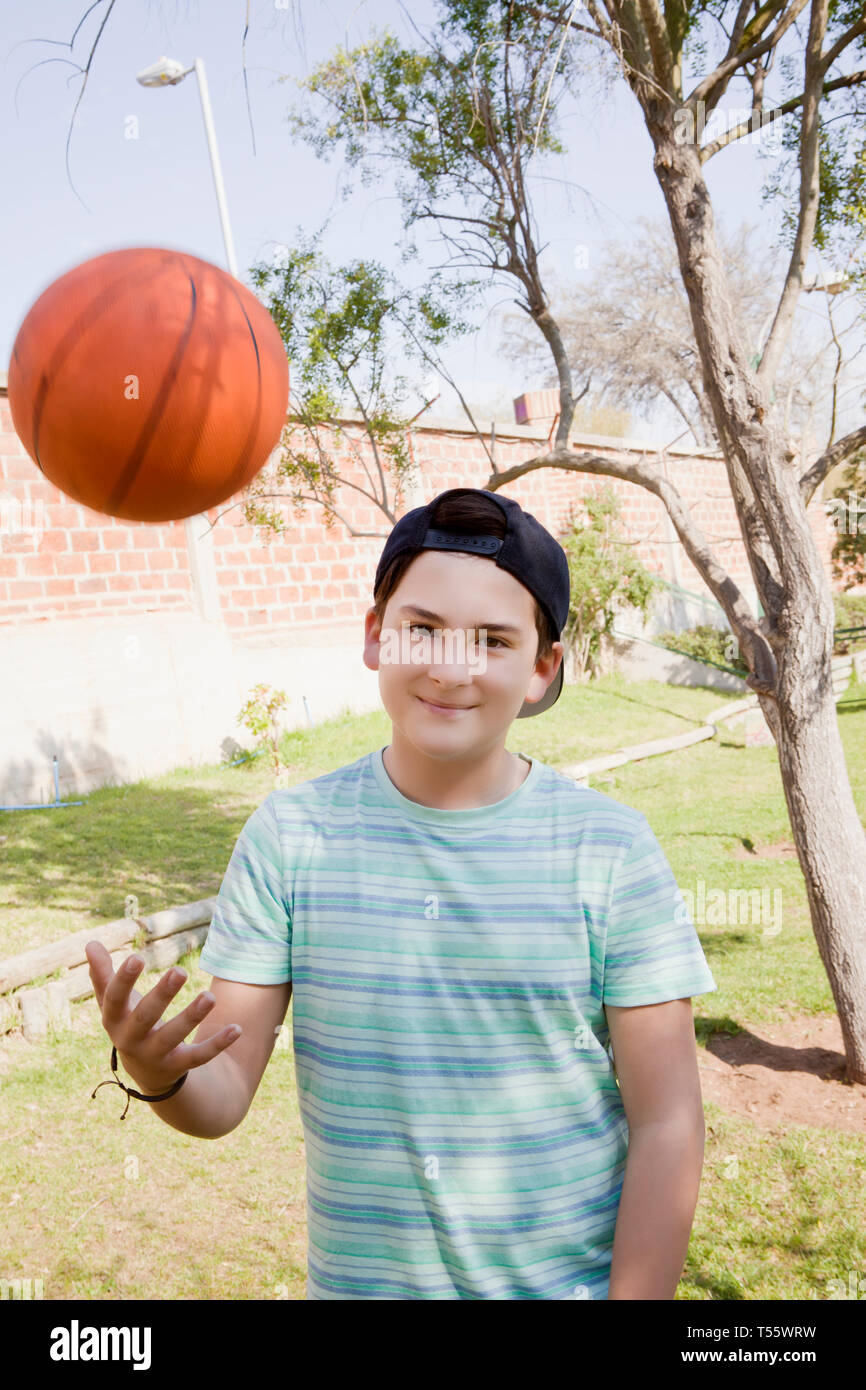 Teenage boy throwing basketball Stock Photo - Alamy