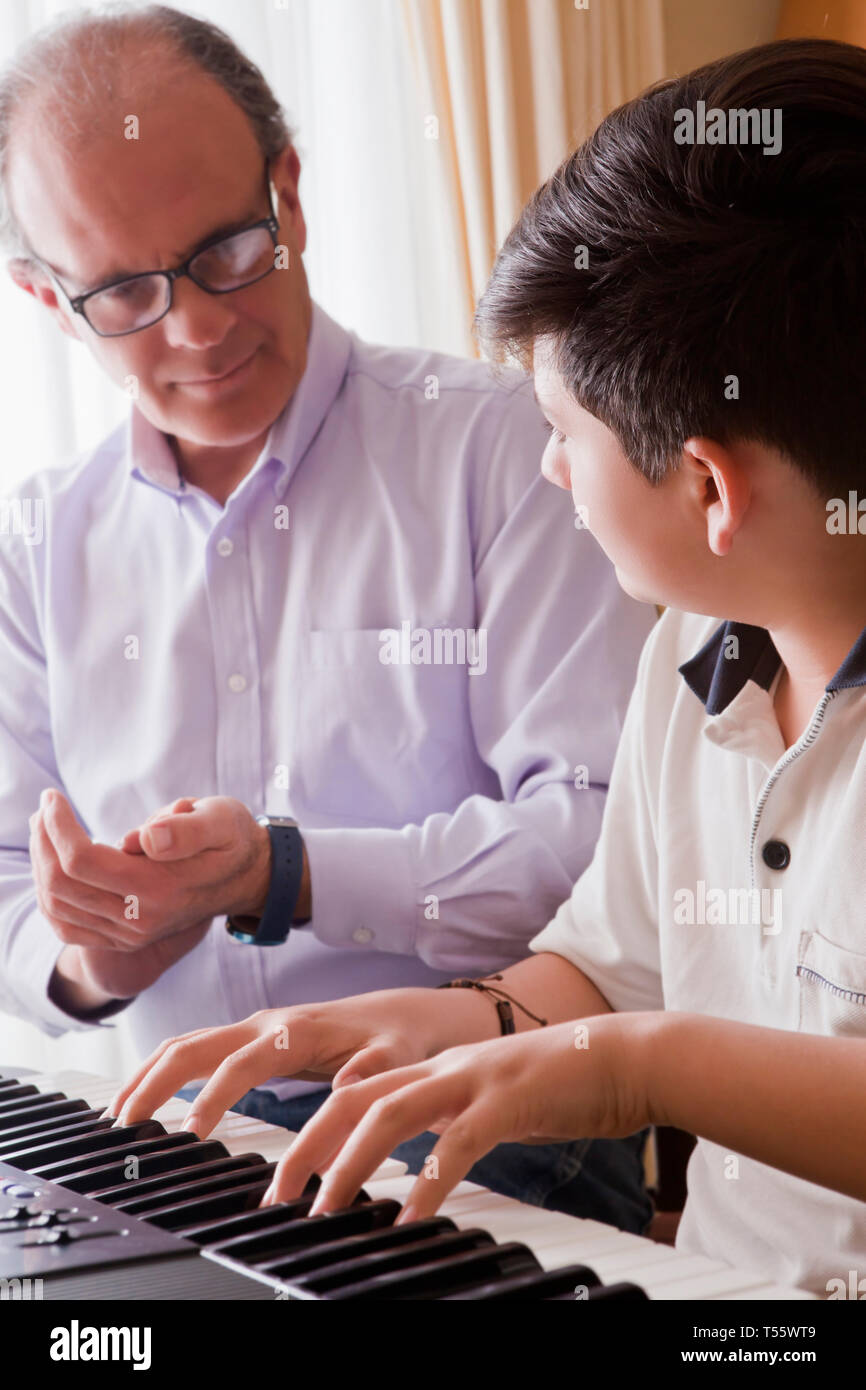 Father teaching his son piano Stock Photo - Alamy