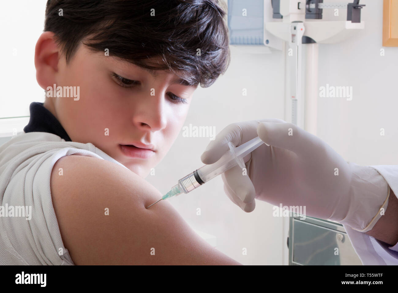 Teenage boy getting vaccination Stock Photo - Alamy
