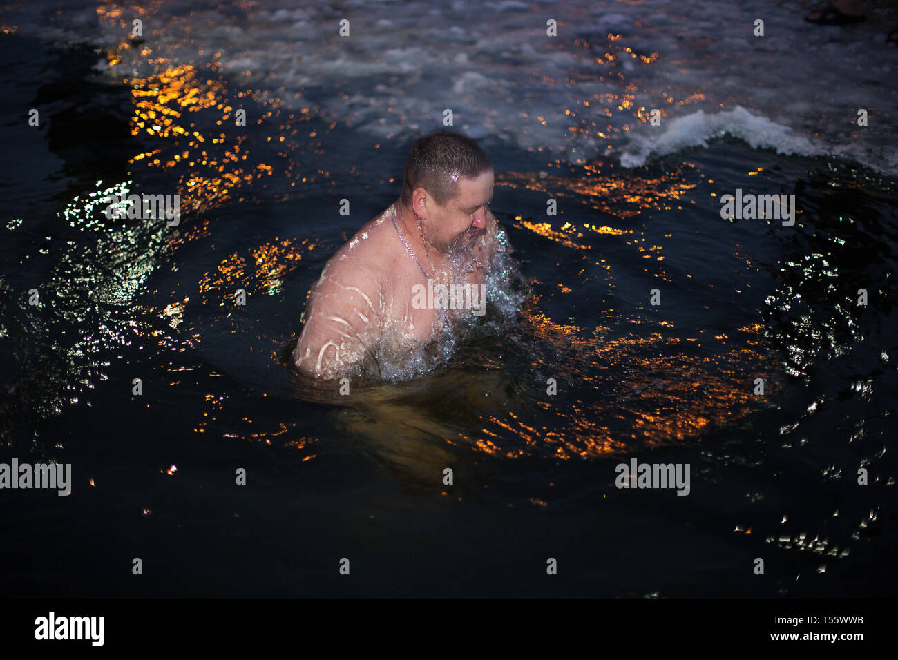 Day of the Cross Baptism.Dive into the ice hole at the baptism of the ...