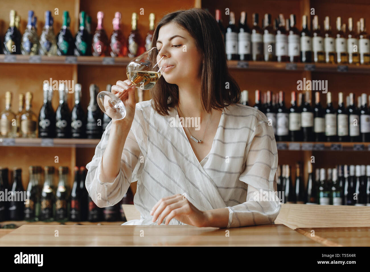 Young woman drinking white wine hi-res stock photography and images - Alamy