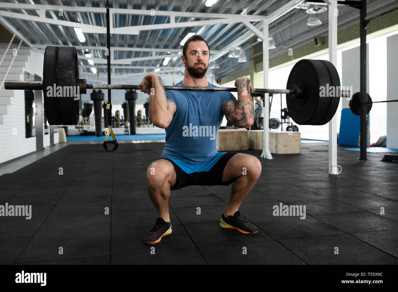Mid adult man weight lifting in gym Stock Photo - Alamy
