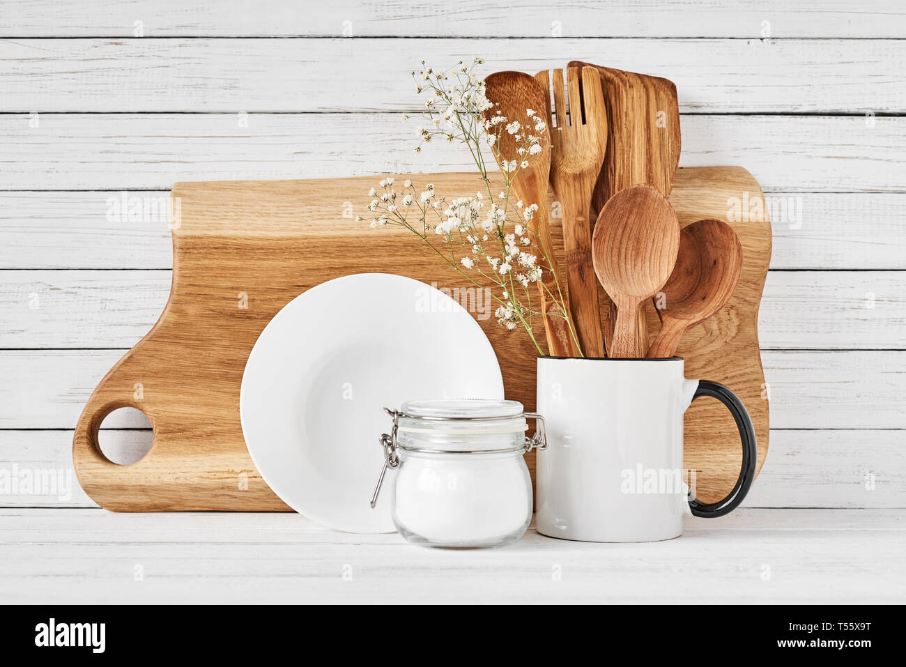 Kitchen tools and cutting board on white table. Kitchen utensils ...