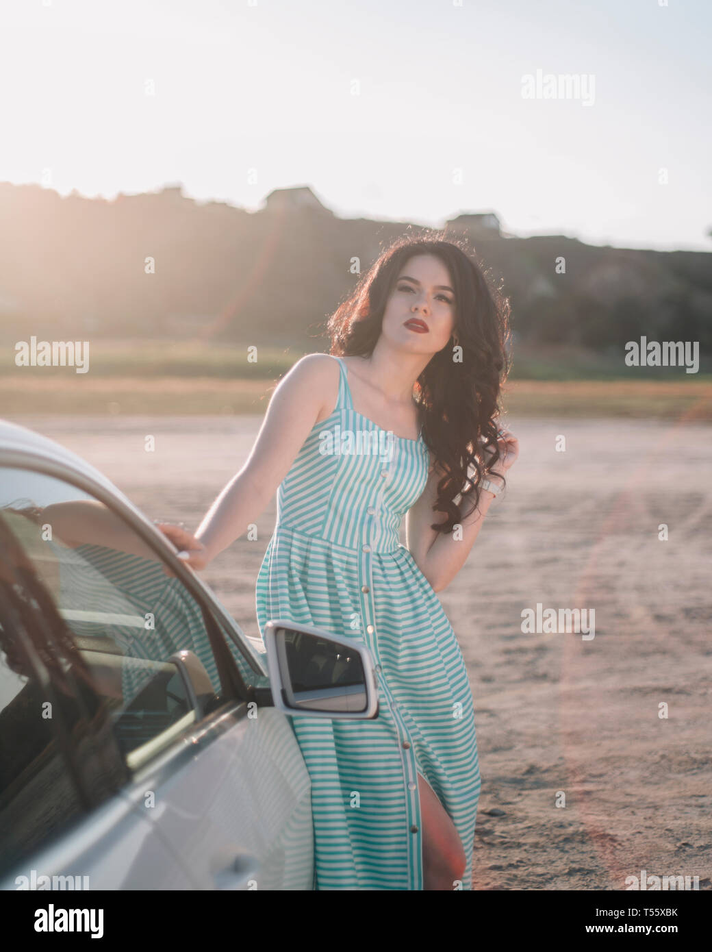 Woman on car red dress hi-res stock photography and images - Alamy