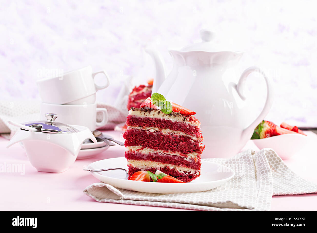 Red velvet cake on a pink background. Tea drinking. Table setting Stock ...