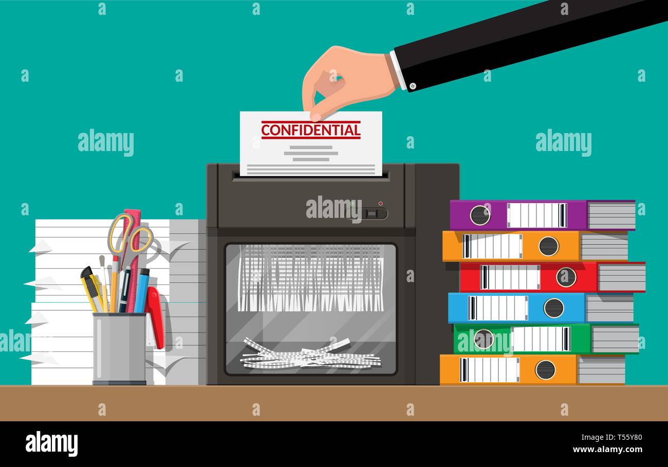 Hand putting document paper in shredder machine. Torn to shreds ...