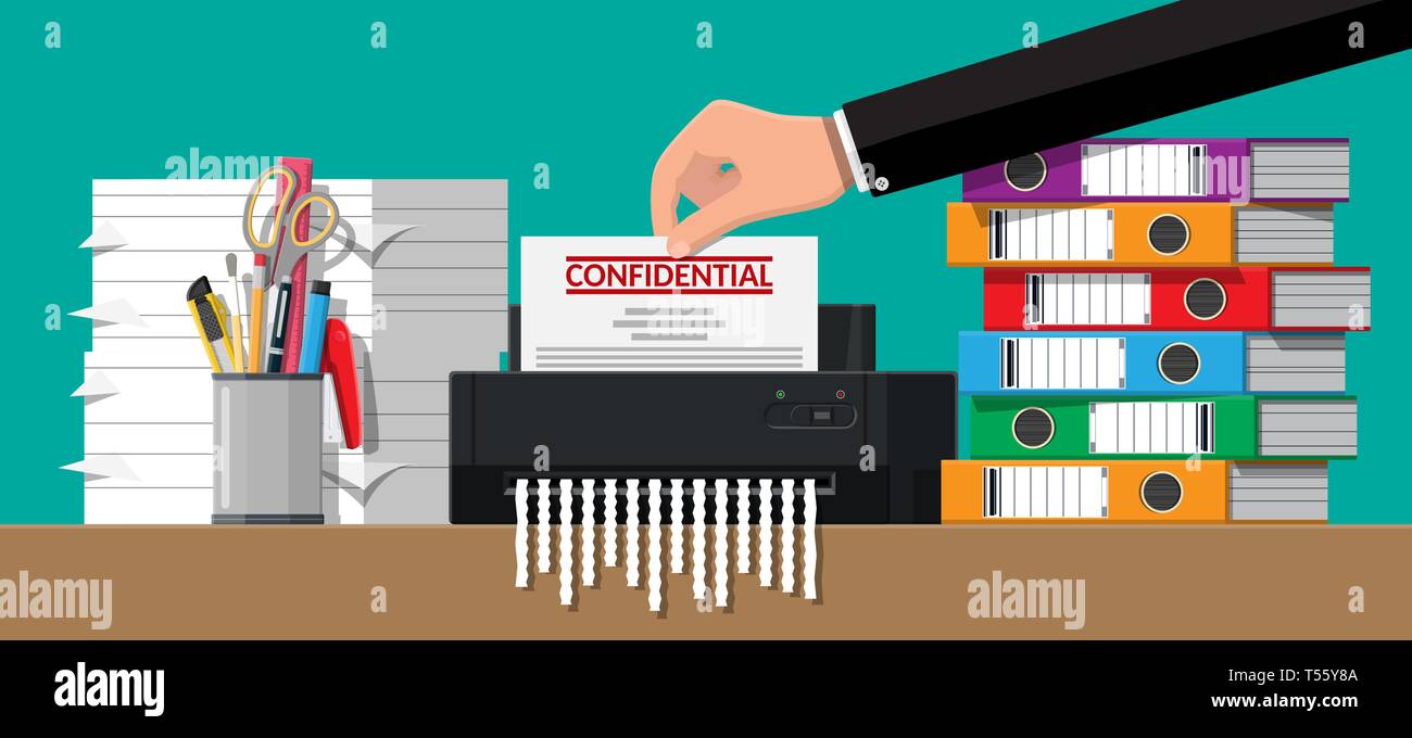 Hand putting document paper in shredder machine. Torn to shreds ...