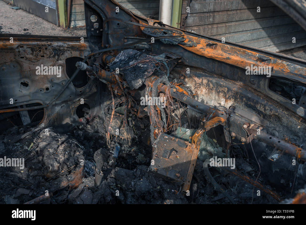 Interior of a completely burned car in the suburbs with noting useful ...