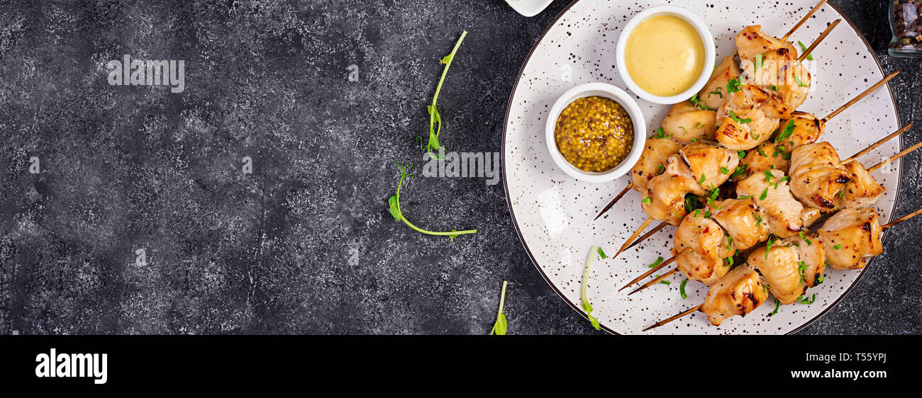 Grilled chicken kebab on a dark background. Banner. Copy space. Top ...