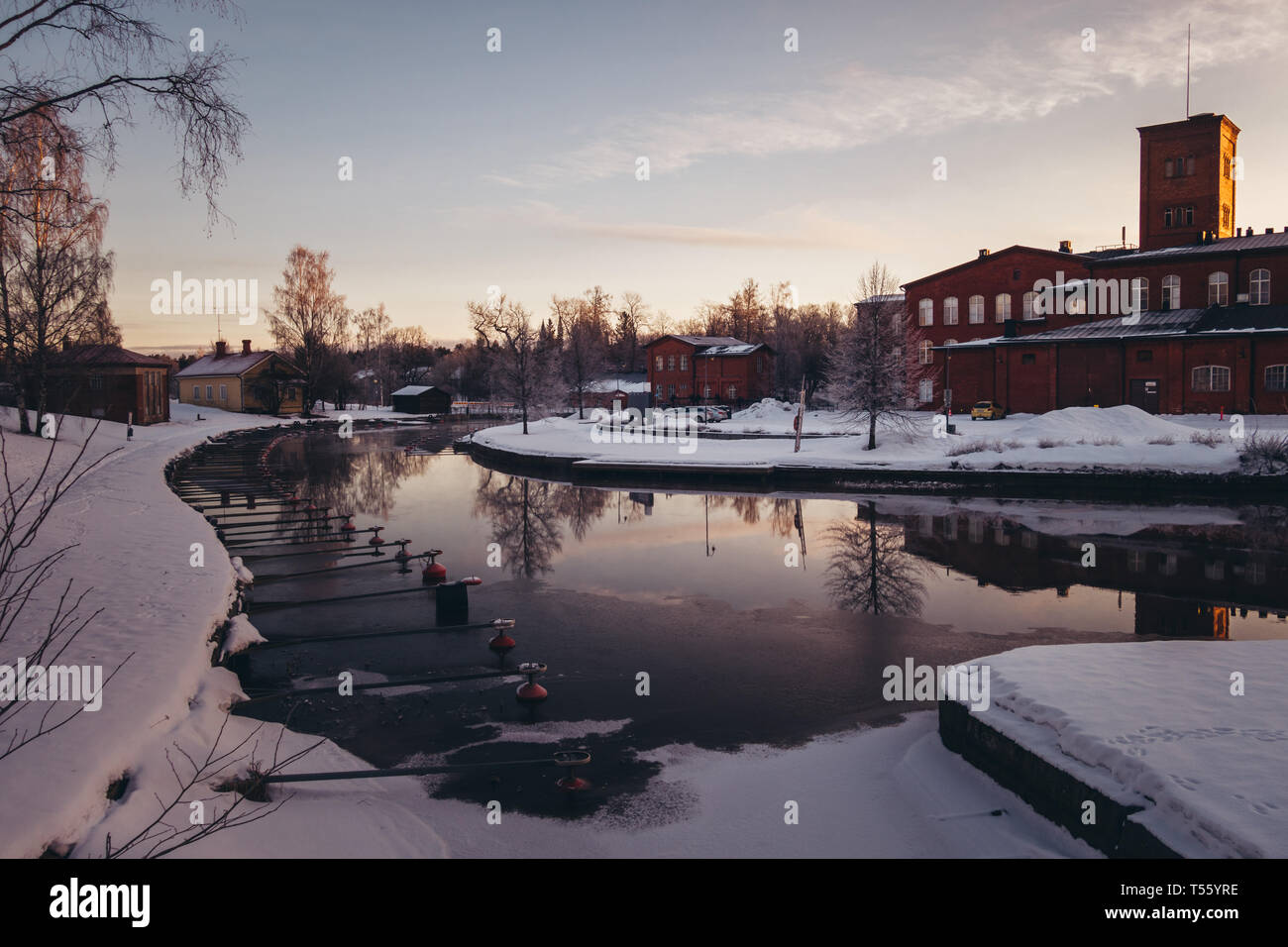 Winter morning with sunrise at the old spinning mill by the river in ...