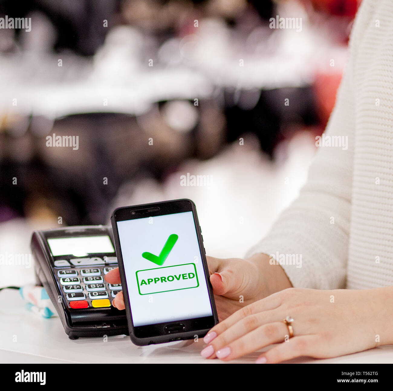 POS terminal, Payment Machine with mobile phone on store background ...