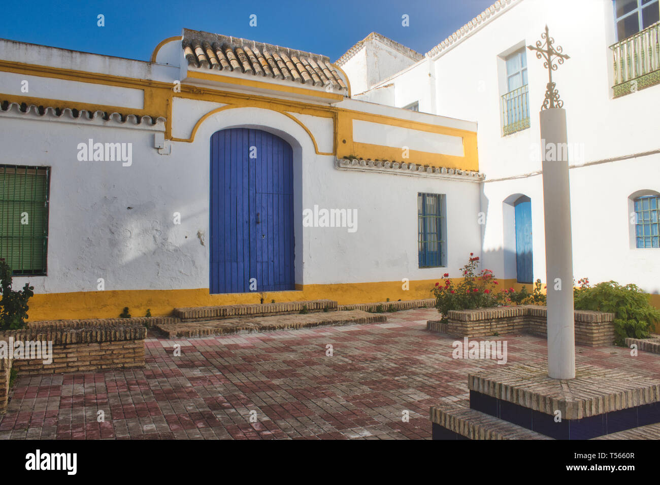 Spanish brightly colored courtyard or patio in the sun with an ornate ...