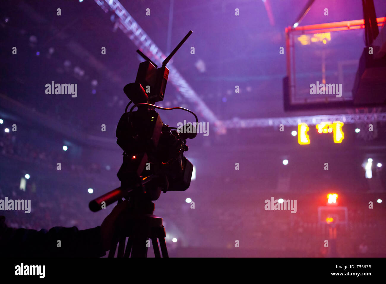 professional camera filming basketball game live in sports arena Stock ...