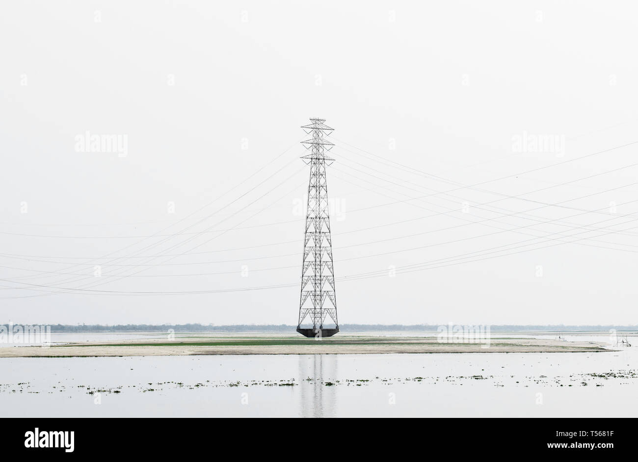 Pylon power electricity tower crossing river water on pier Stock Photo ...