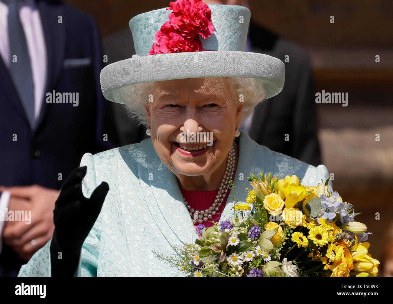 Queen Elizabeth II is presented with flowers as she leaves the Easter ...